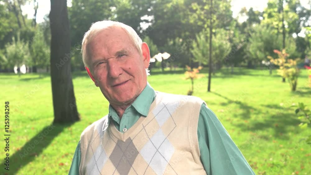 Senior man looking at camera. Elderly male on park background. Your ...