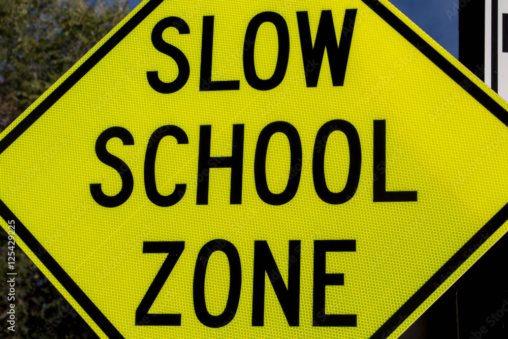 Yellow diamond Slow School Zone sign Stock Photo | Adobe Stock