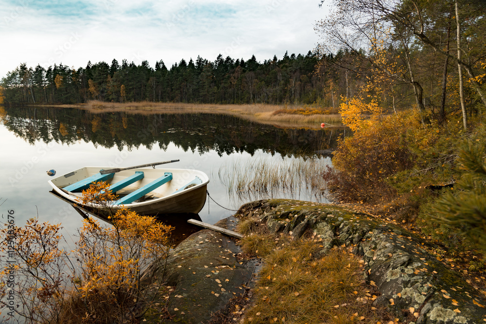 Rowing boat at the shore of a lake in Smaland, Southern Sweden, in ...