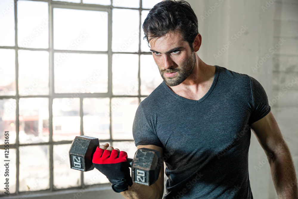 Artistic lighting on fit lean muscular handsome bodybuilder in tough ...