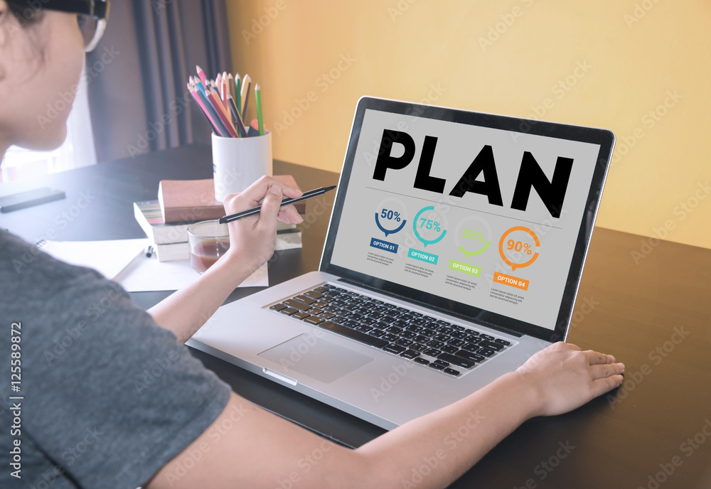 business hand typing on a laptop keyboard with Plan homepage on the ...