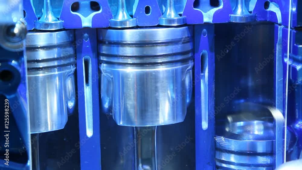 Cross section of a working combustion engine with pistons moving up and ...