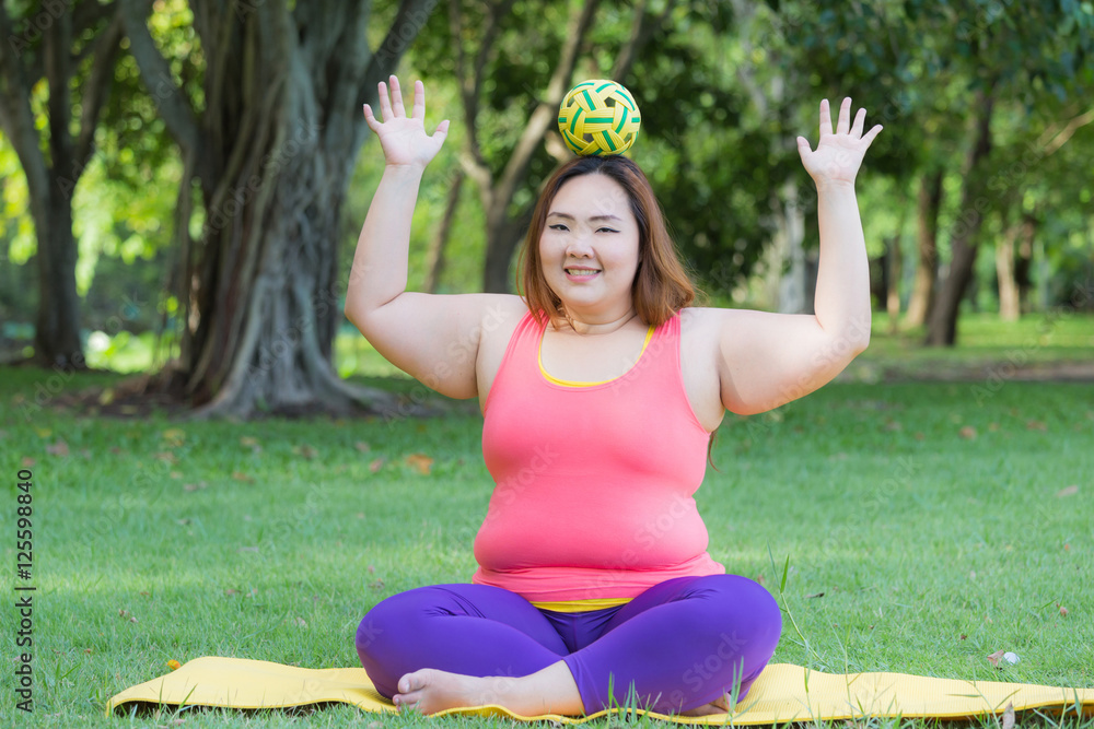 Beautiful fat woman playing with sepak takraw ball on the mat. Stock ...