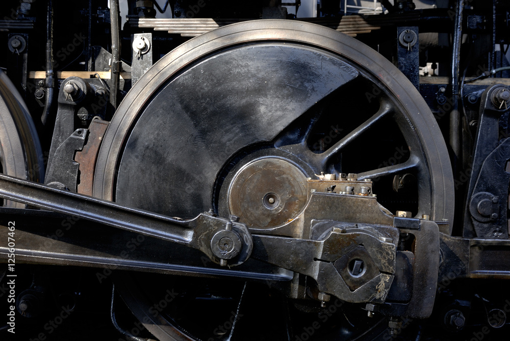 Steam locomotive wheels and rods closeup. Detail of mechanical parts ...