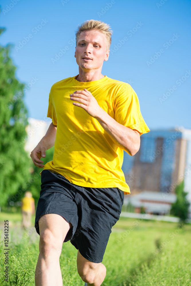 Running man jogging in city street park at beautiful summer day. Sport ...