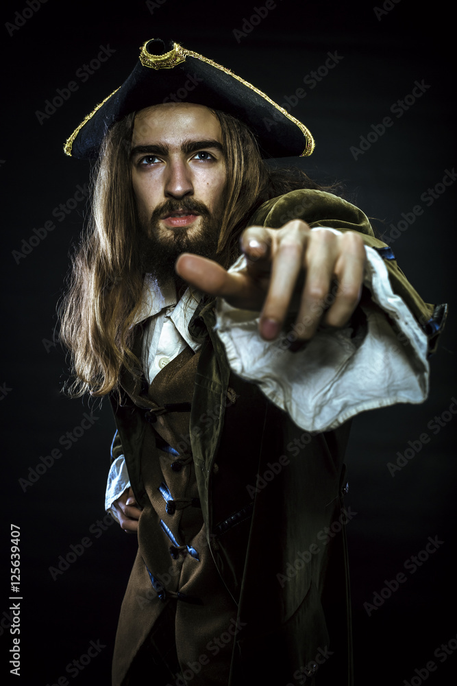 portrait of bearded and hairy pirate pointing into the distance ...