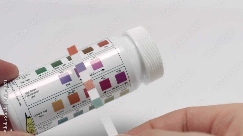 Check quality of water with test strip, comparing results Stock Video ...