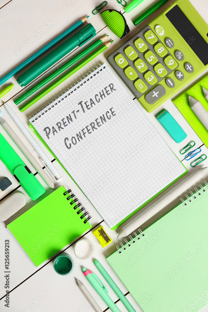 Text PARENT-TEACHER CONFERENCE written in notebook. Stationary on white ...
