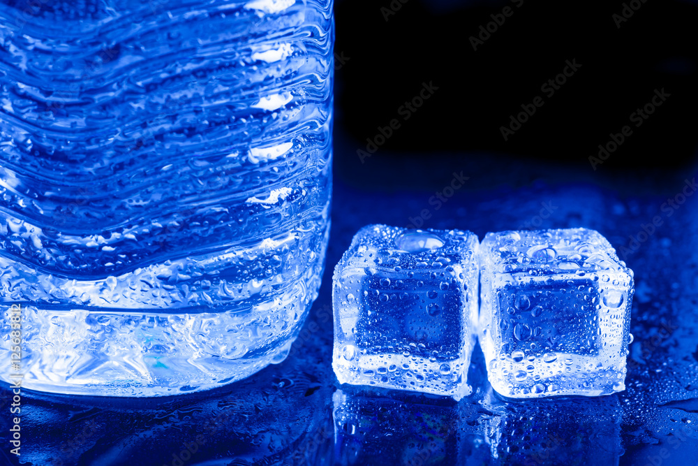 Pile of different wet ice cubes on black background with blue li Stock ...