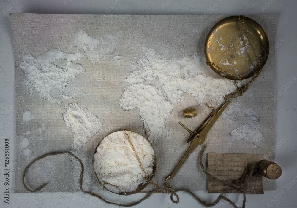 wheat flour in the form of a world map. Food, scales vintage. top view ...