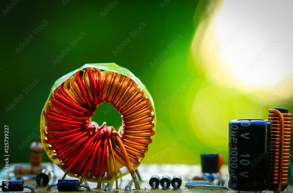 Electromagnetic coil, inductor. Small winding coils and fuse are ...