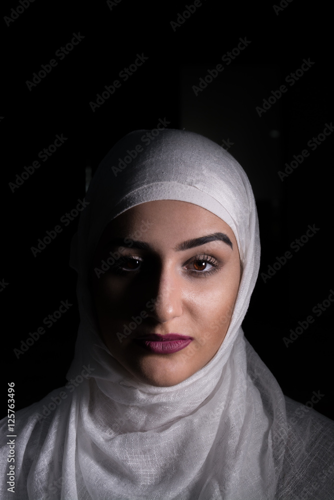 Muslim Girl Isolated in Dark Stock Photo | Adobe Stock