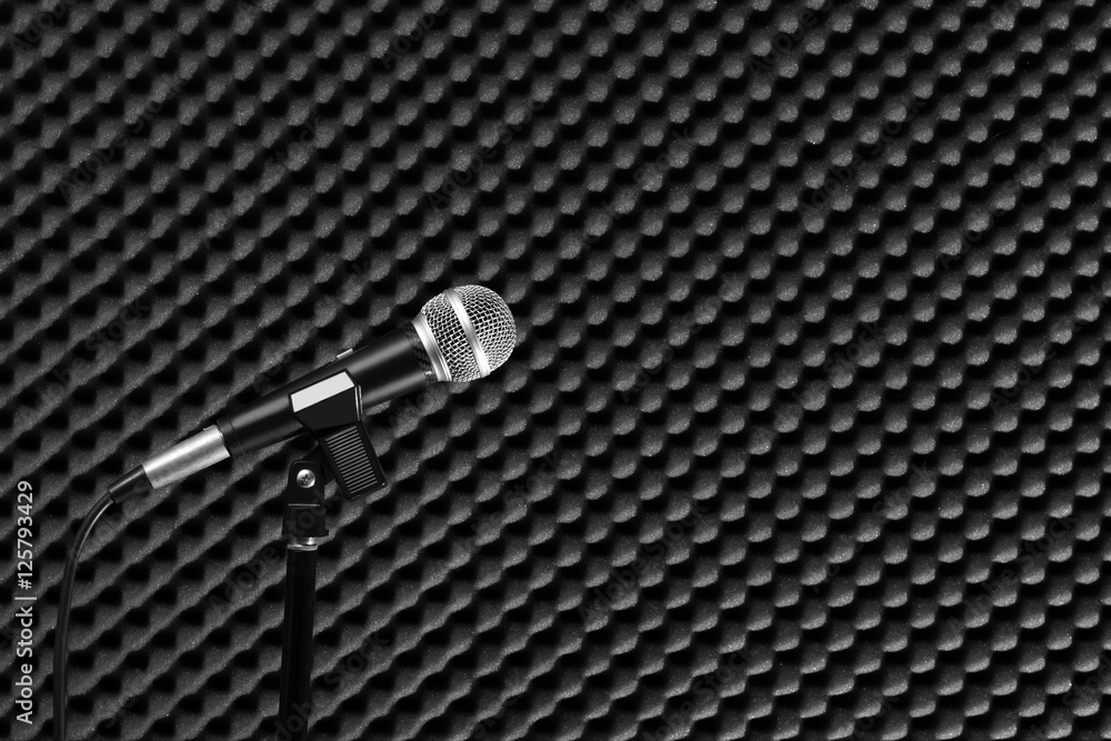 dynamic microphone on acoustic board background in recording studio for ...