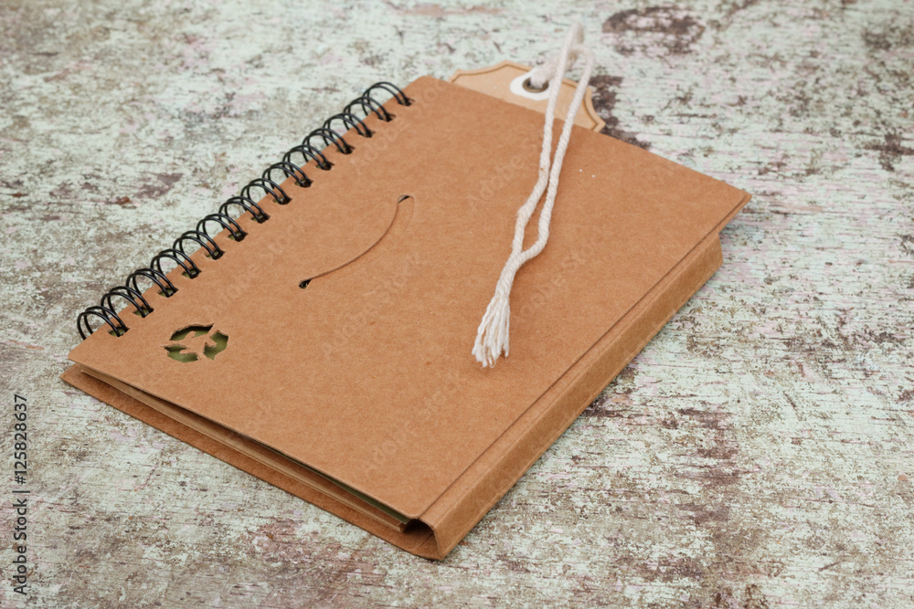 Recycle paper note with recycle symbol on front cover on wooden table ...