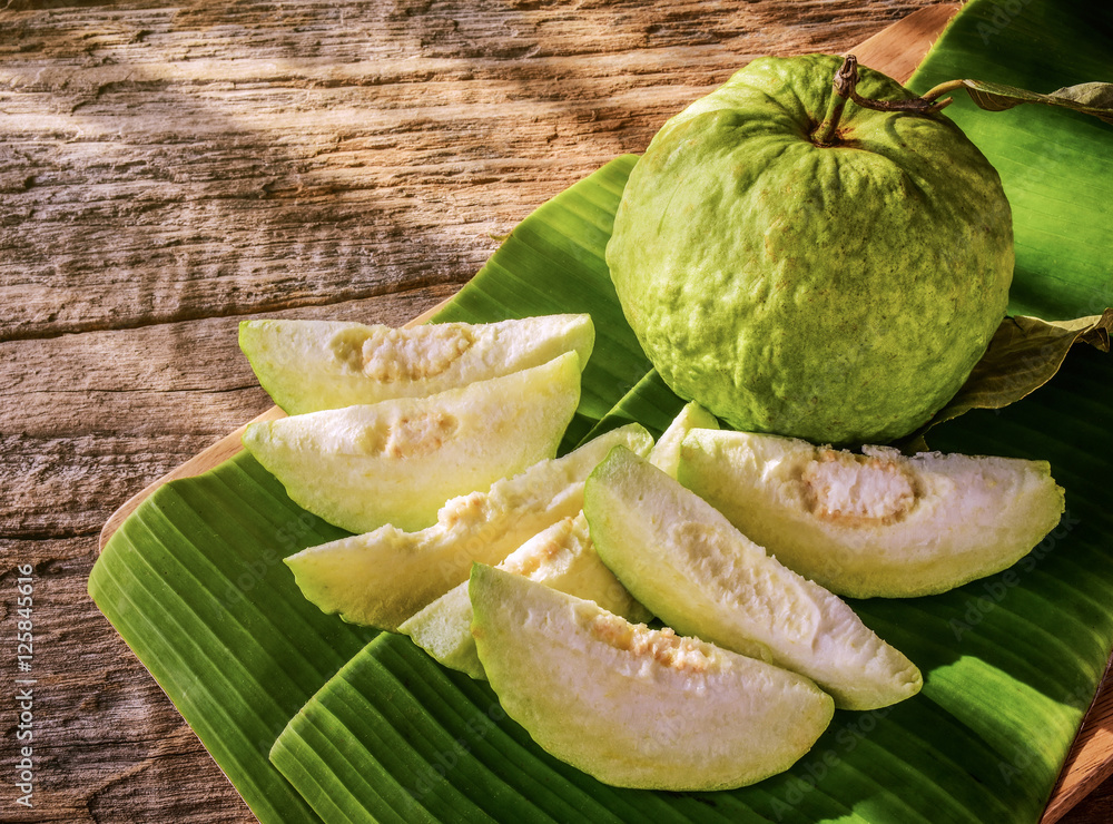 Guava,prepared for serving on banana leaves background.Fresh guava ...