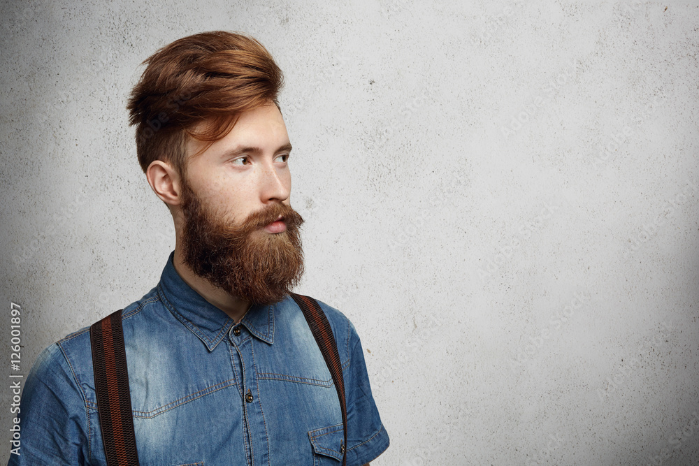 Casual young man with stylish fuzzy beard dressed in denim shirt and ...