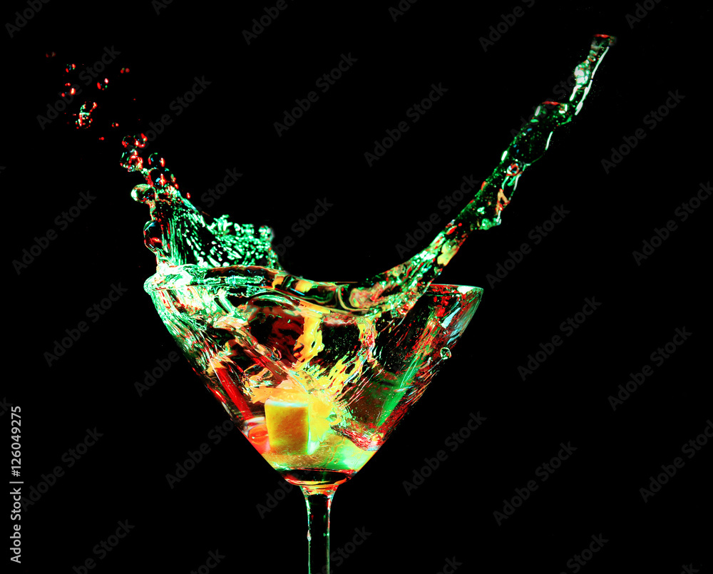 Colorful cocktail with splash on dark background Stock Photo | Adobe Stock
