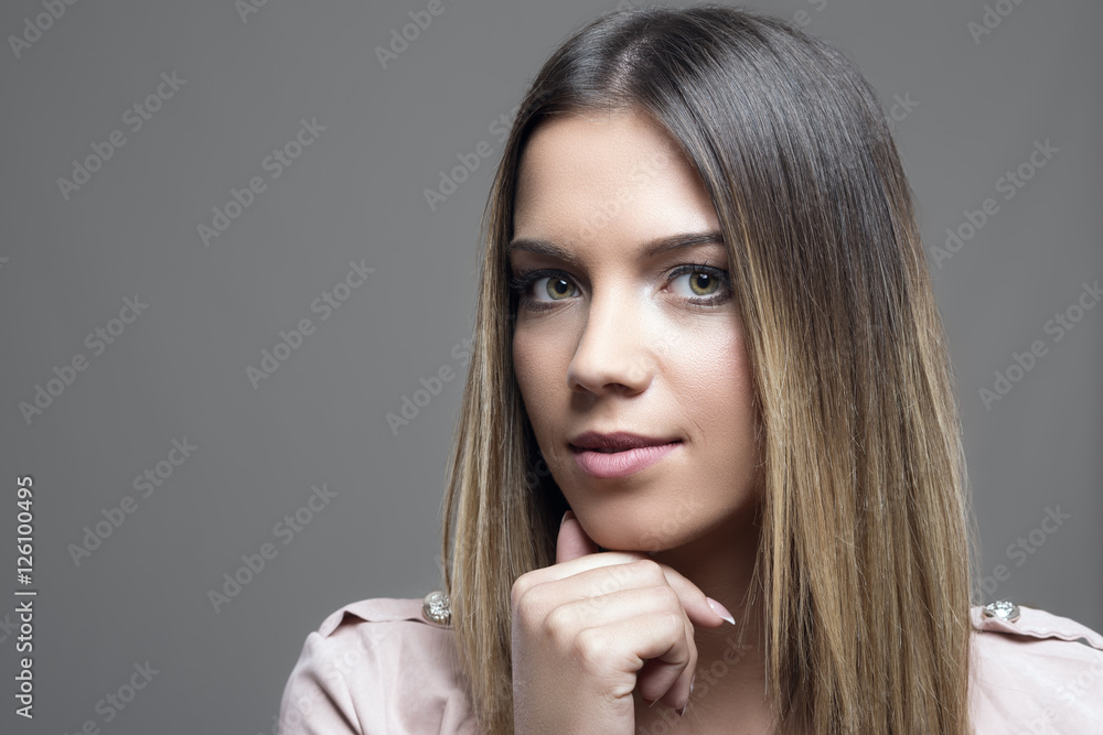 Gorgeous beauty with perfect complexion posing with hand on her chin ...