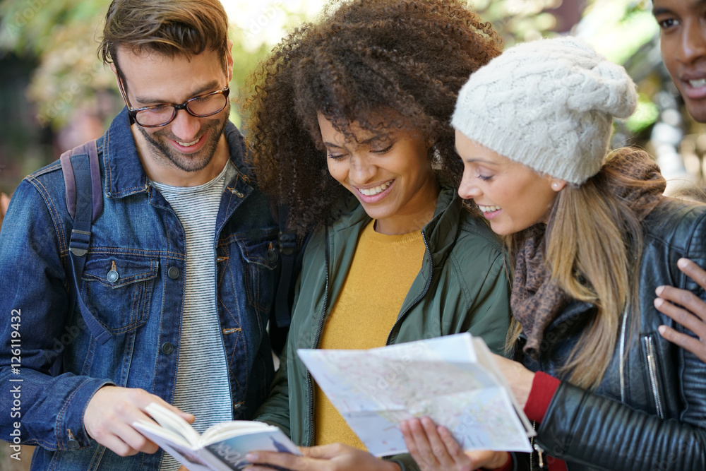 Friends visiting New York reading map and city guide Stock Photo ...