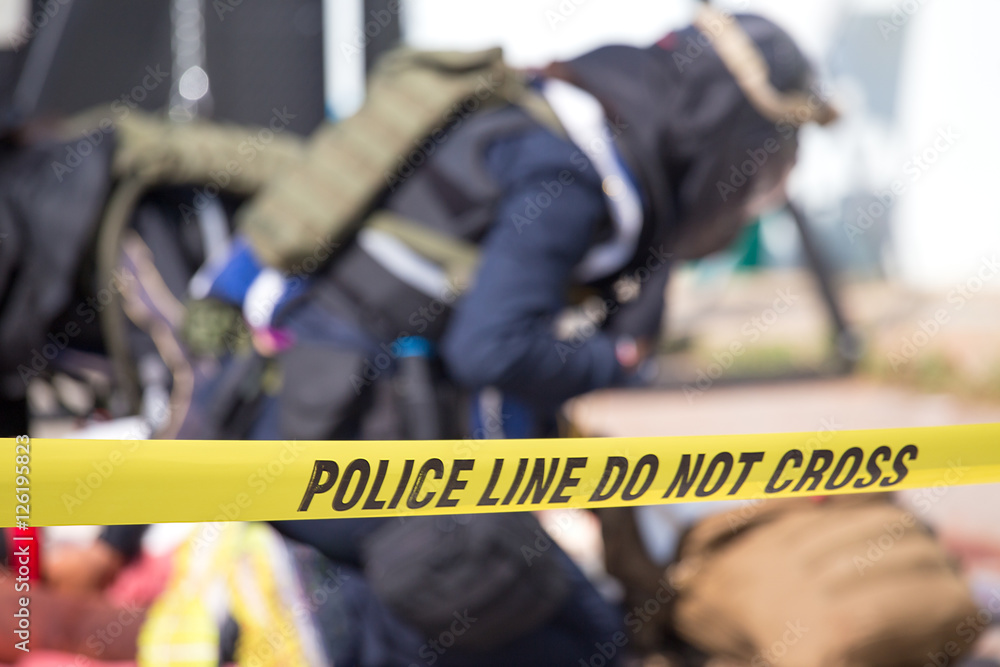 police line do no cross with blurred law enforcement background Stock ...