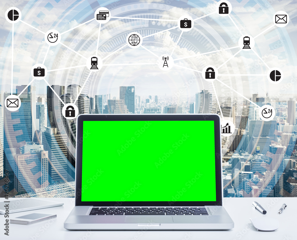 Blank green screen laptop computer with night cityscape and digital ...