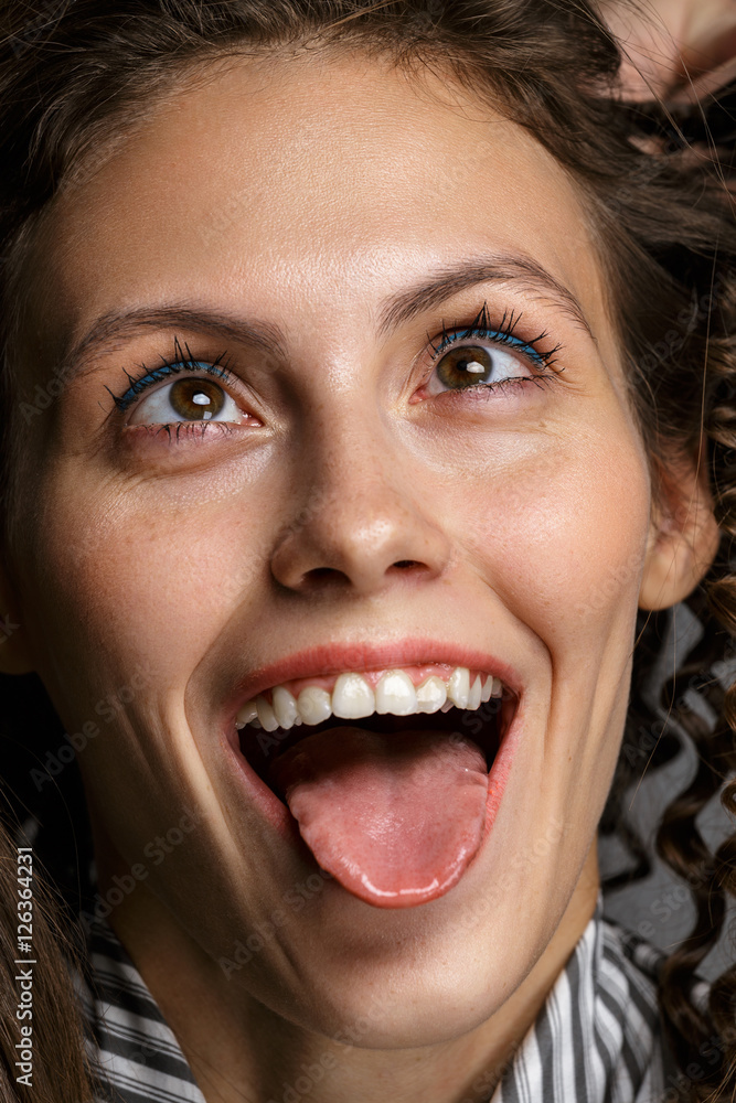 Portrait of a sensual beautiful young woman showing long tongue Stock ...