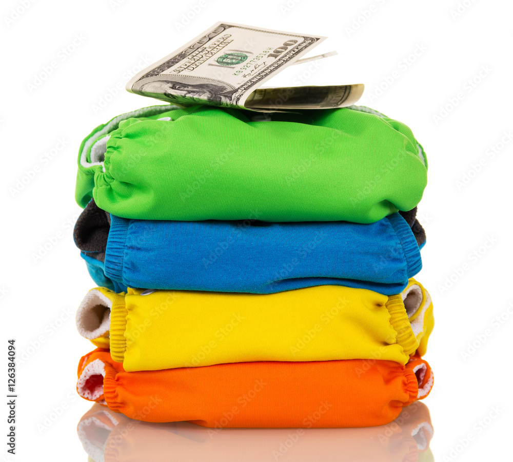Stack modern cloth diapers and dollars isolated on white background ...