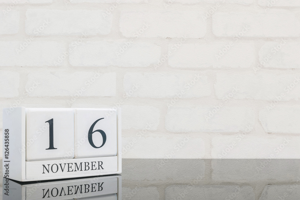 Closeup white wooden calendar with black 16 november word on black ...