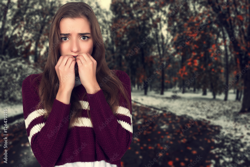 Portrait of a pretty woman with fear face standing over background of ...