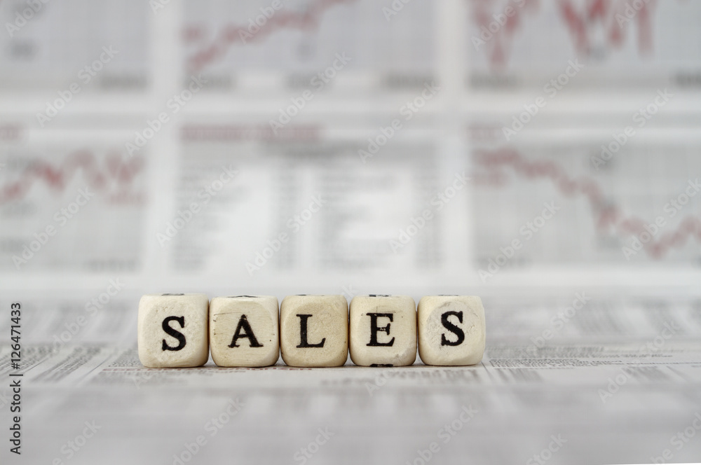 Sales word built with letter cubes on newspaper background Stock Photo ...