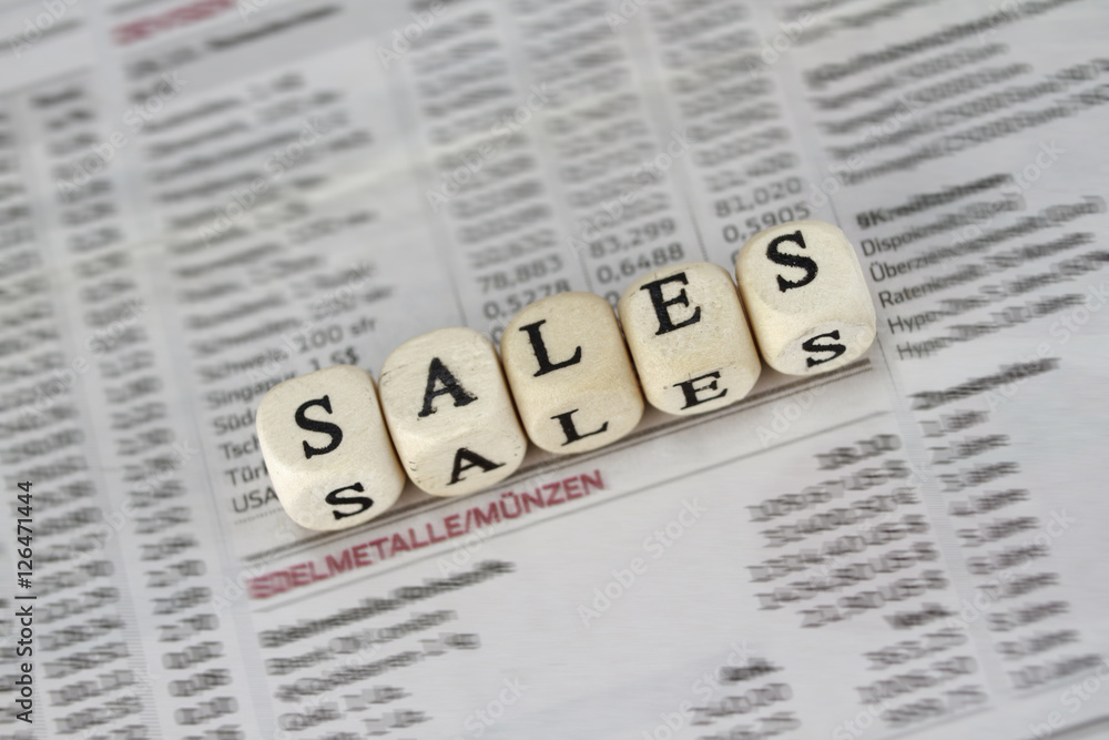 Sales word built with letter cubes on newspaper background Stock Photo ...