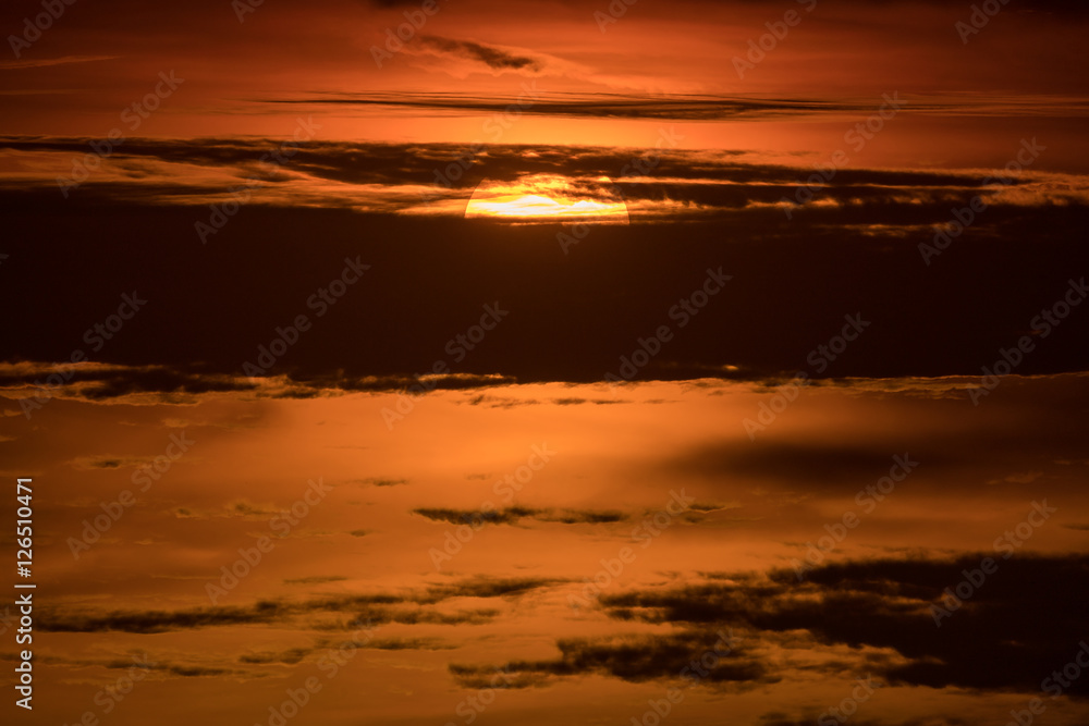 Beautiful Sunshine behind dark clouds on evening sky Sun try to shine ...