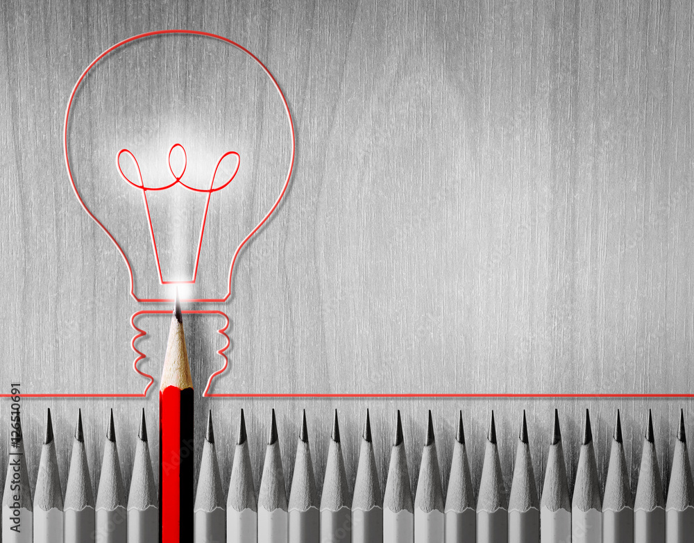 Red pencil drawing light bulb in the middle of the black and white ...