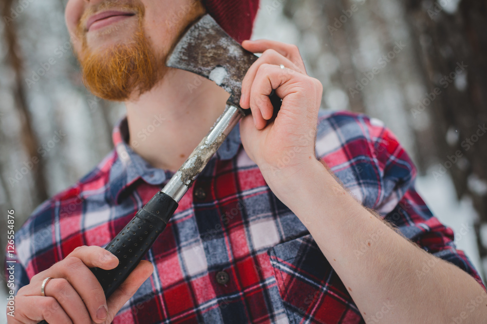 bearded man with an hatchet in the winter forest Stock Photo | Adobe Stock