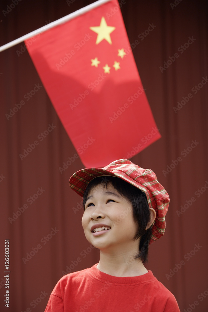 Portrait of little girl standing under Chinese flag Stock Photo | Adobe ...