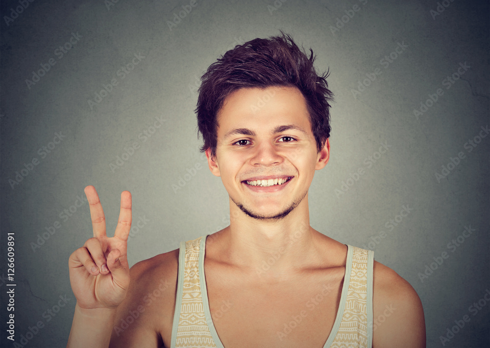 Young man, handsome student holding up peace victory, two sign Stock ...