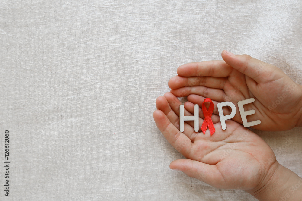 HOPE word with Red Ribbons on hands, toning copy space background, HIV ...