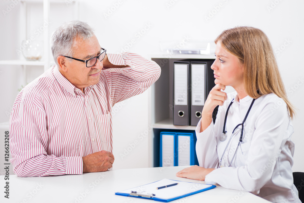 Patient is telling doctor about his health problems. He is having pain ...