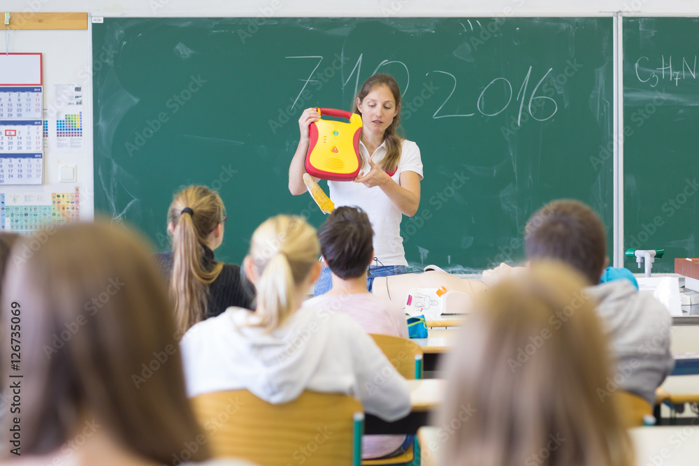 Instructor teaching first aid cardiopulmonary resuscitation course and ...