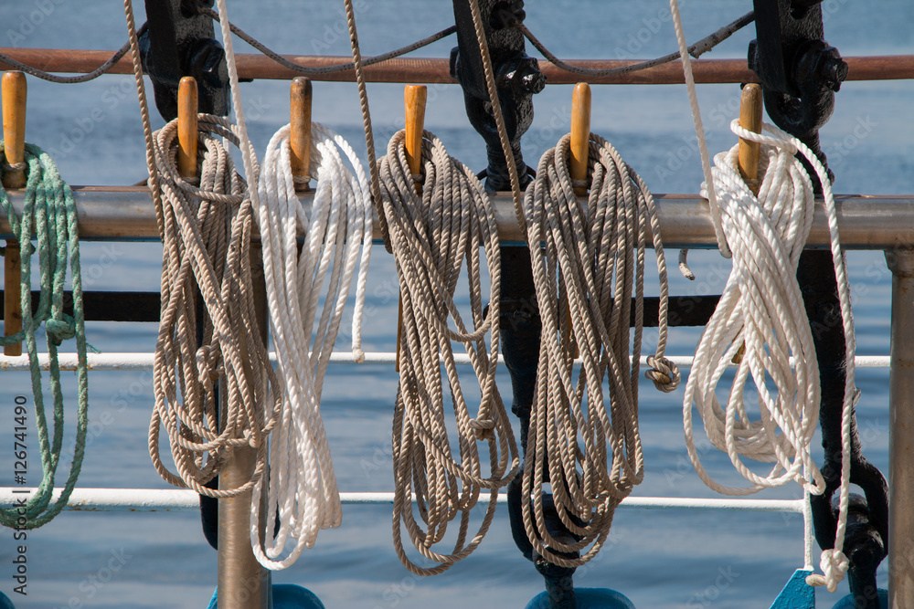 Deck and ropes, rigging on a wooden tall ship sail yacht. Close up view ...