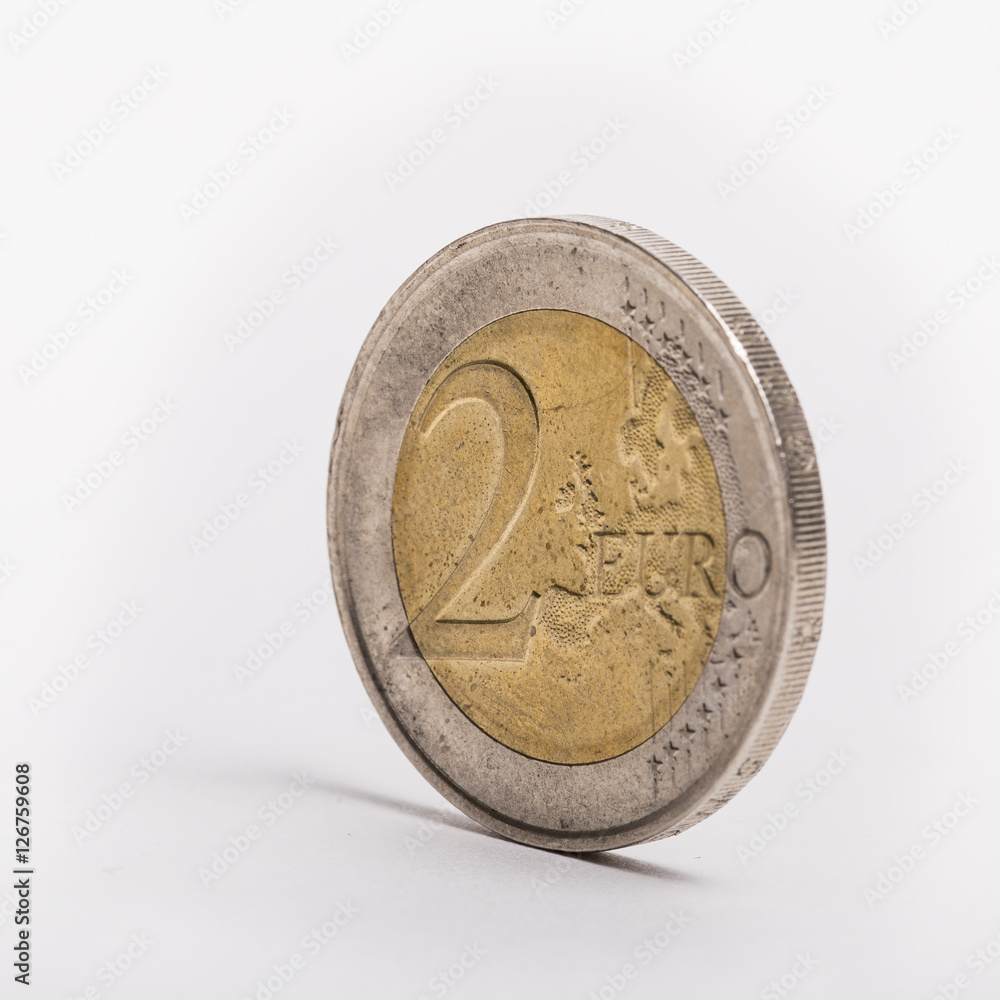 A 2 euro coin standing upright isolated on a white background Stock ...