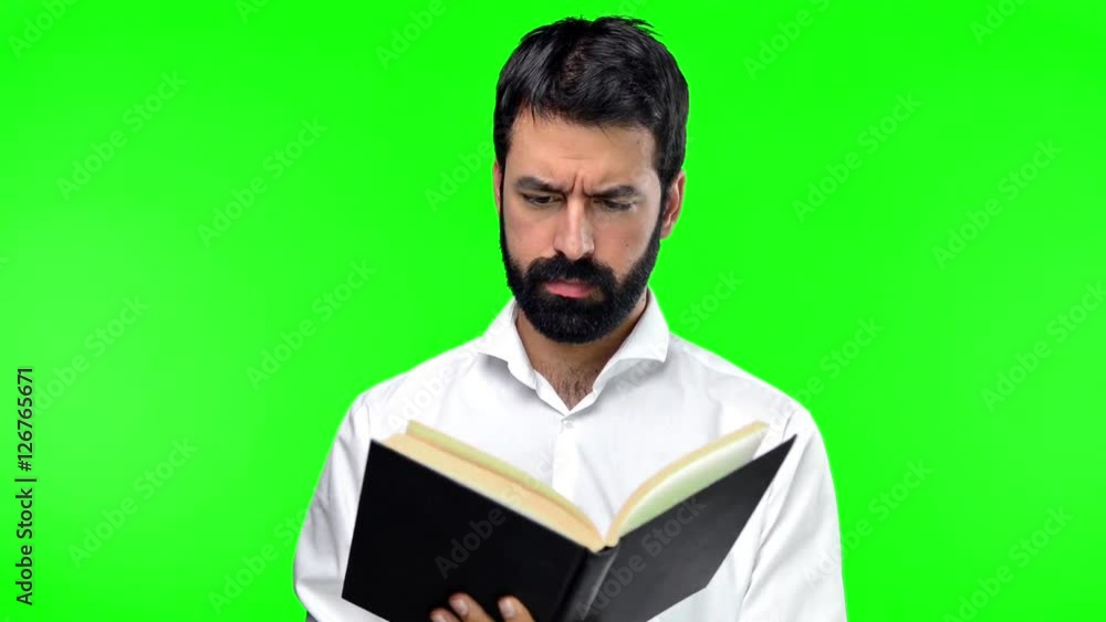 Handsome man reading book on green screen chroma key Stock Video ...