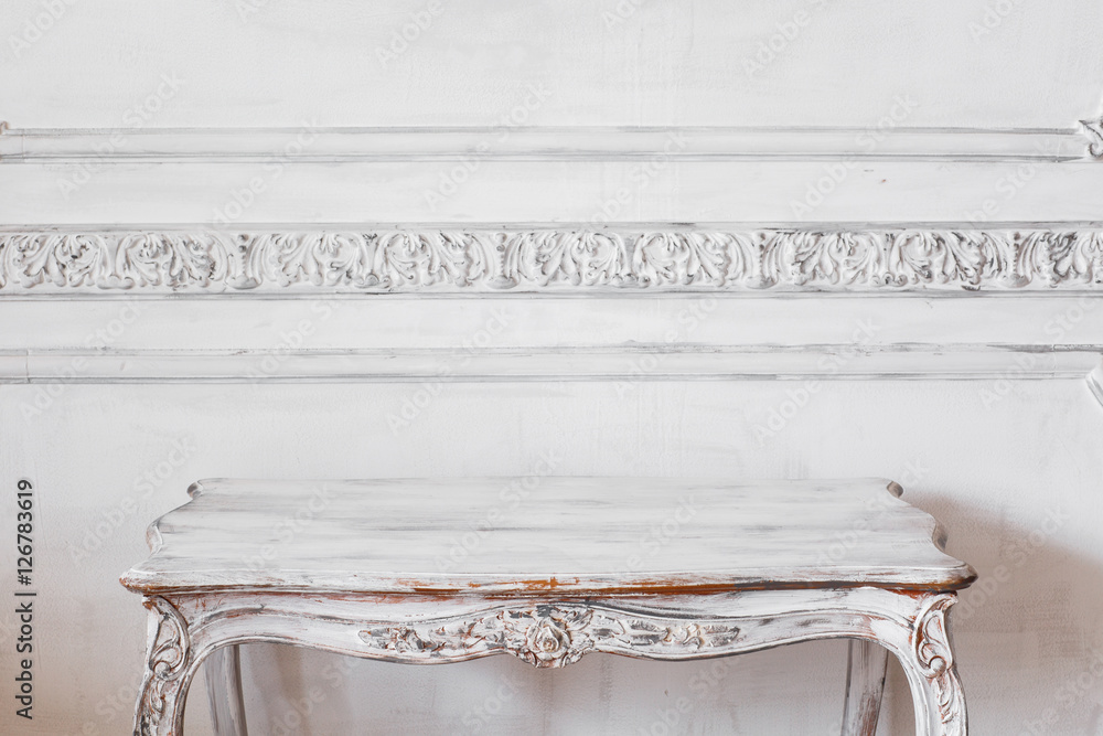 Living room with antique stylish light Coloured table on luxury white ...