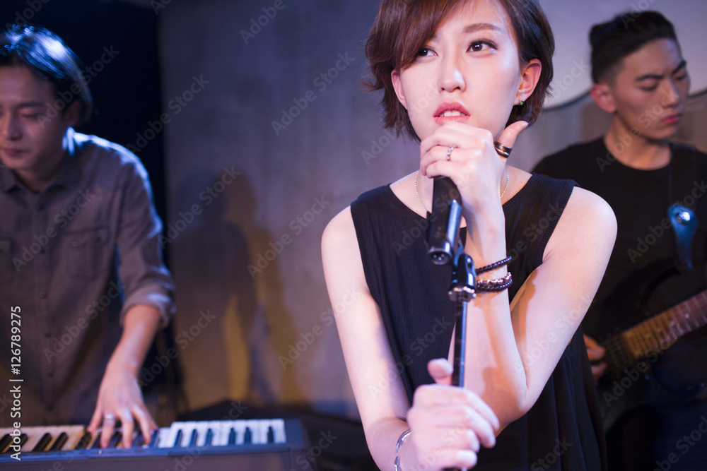 Musical band performing on stage Stock Photo | Adobe Stock