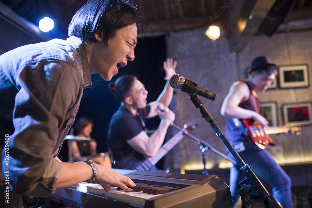 Musical band performing on stage Stock Photo | Adobe Stock