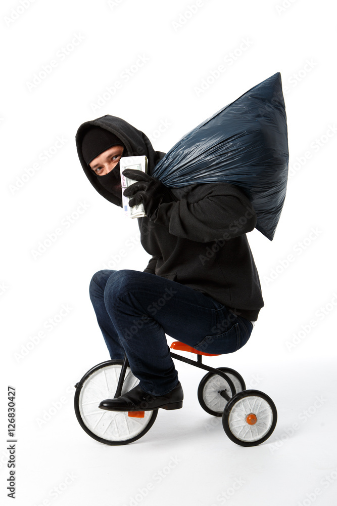 Burglar coming with pack money Stock-Foto | Adobe Stock