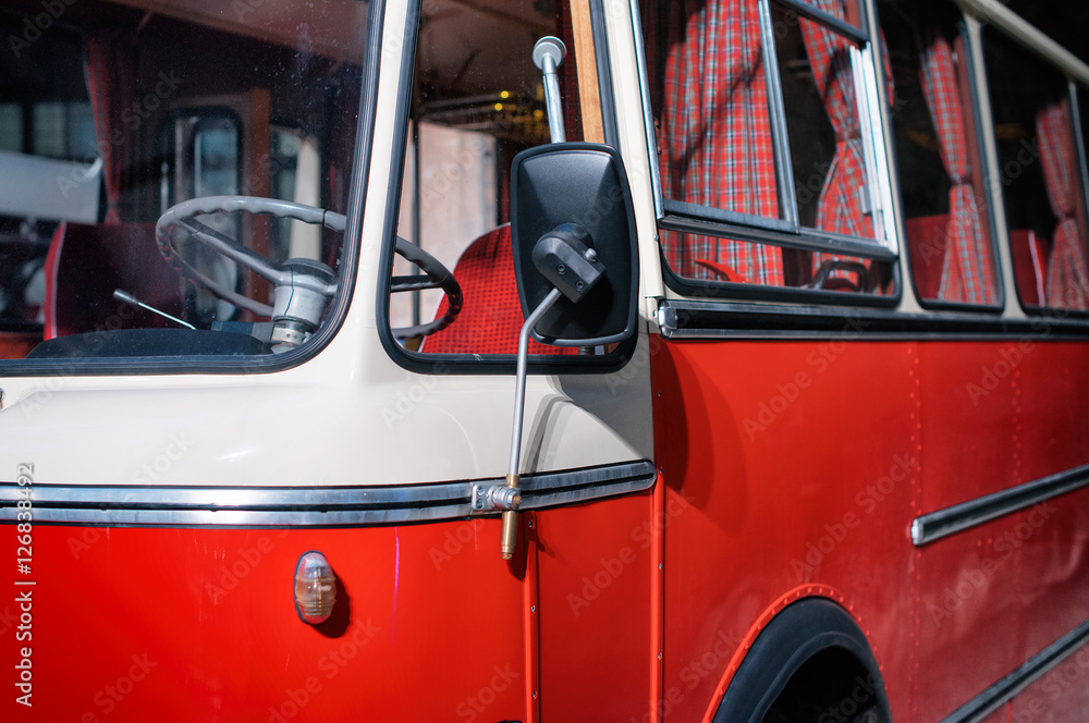 Part of red old retro bus. Stock Photo | Adobe Stock