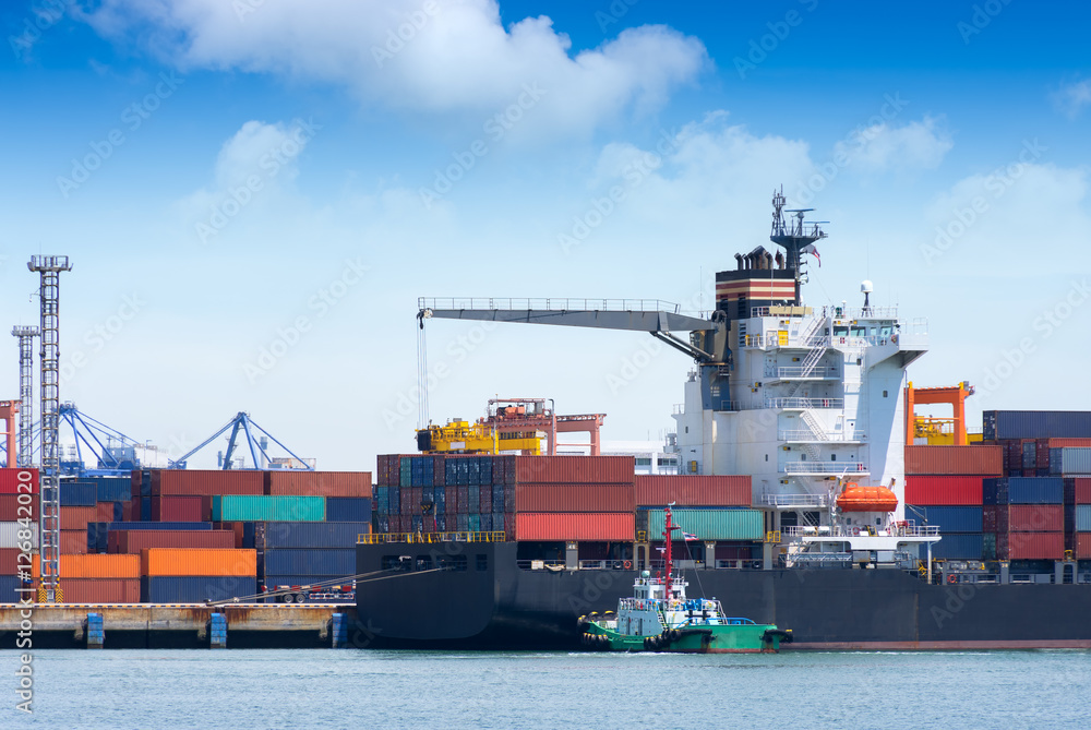 International Container Cargo ship with working crane bridge in ...