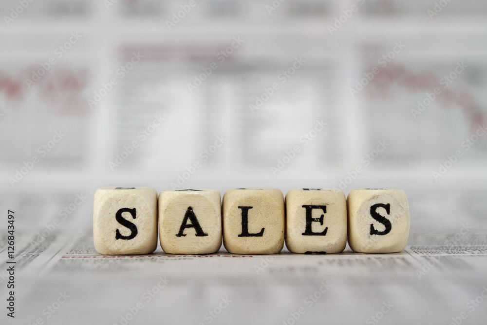 Sales word built with letter cubes on newspaper background Stock Photo ...