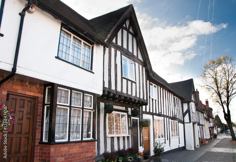 Traditionally built timber framed Tudor homes on a street in the ...